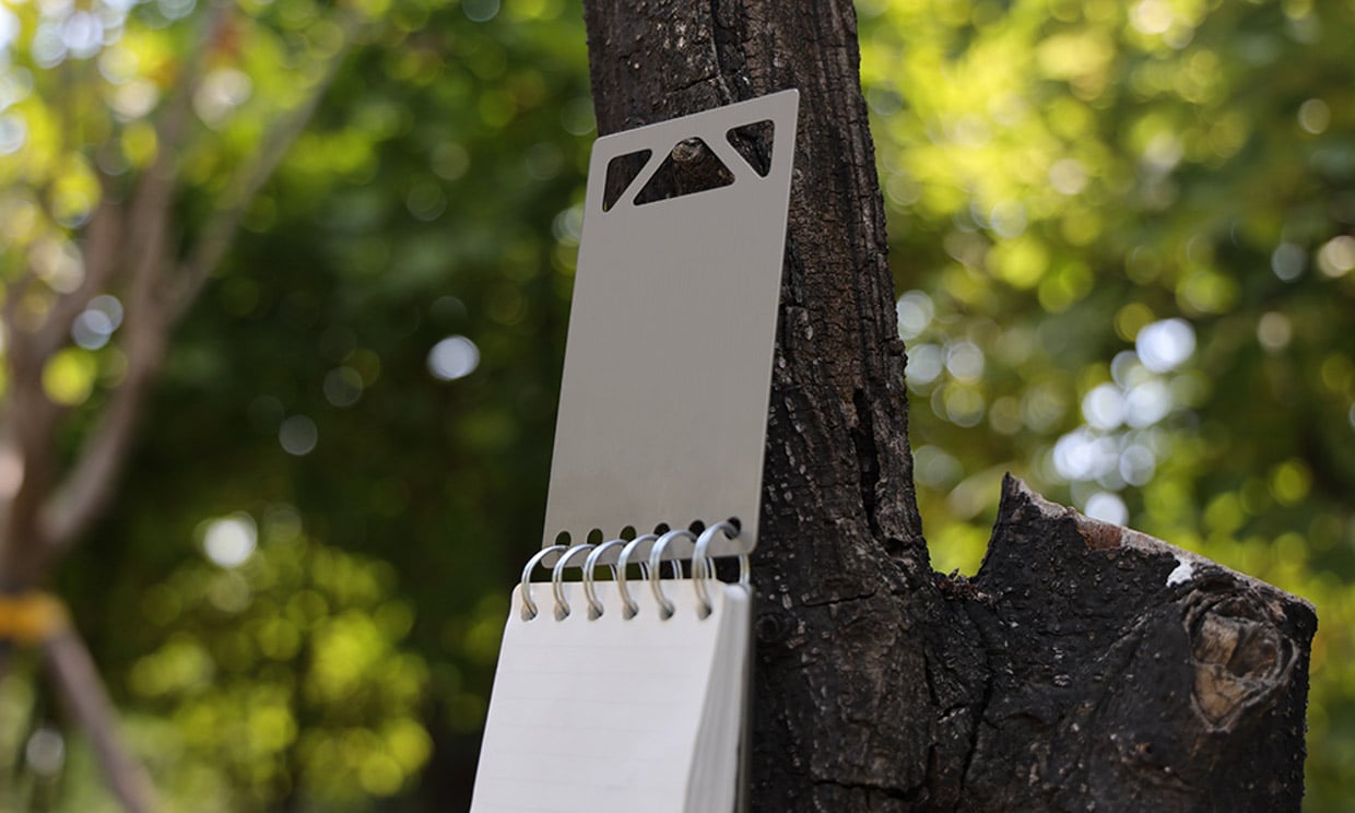 TIX Note Titanium Notebook Handles Rain and Mud and Even Opens Bottles