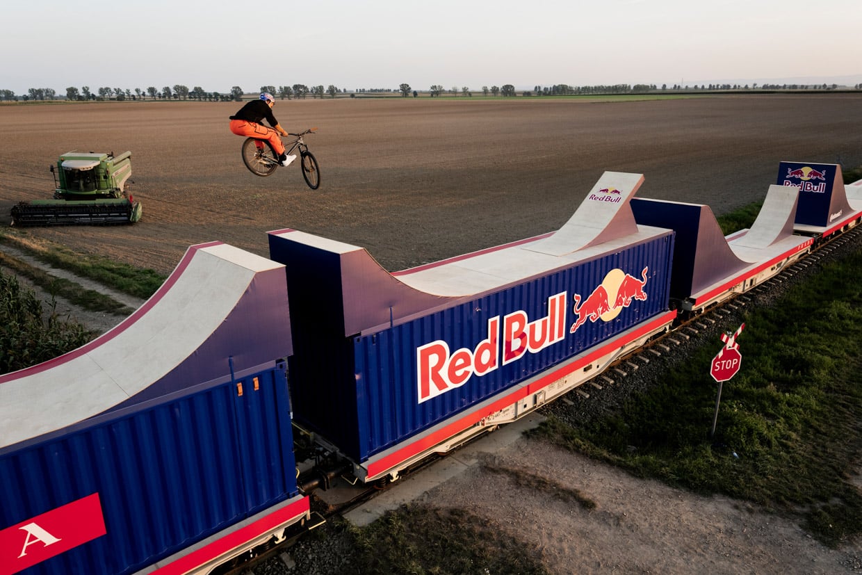 MTB Rider Does Bike Tricks on a Moving Train