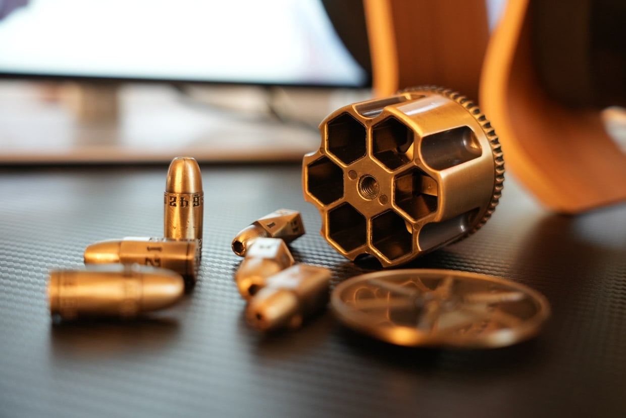 These Metal Dice Look Like Bullets and Pop Out of a Revolver Cylinder